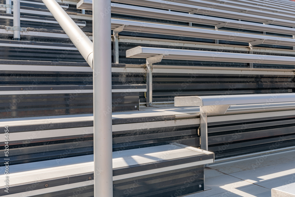 Poster Close-Up of empty metal stadium bleacher seats along aisle with ...