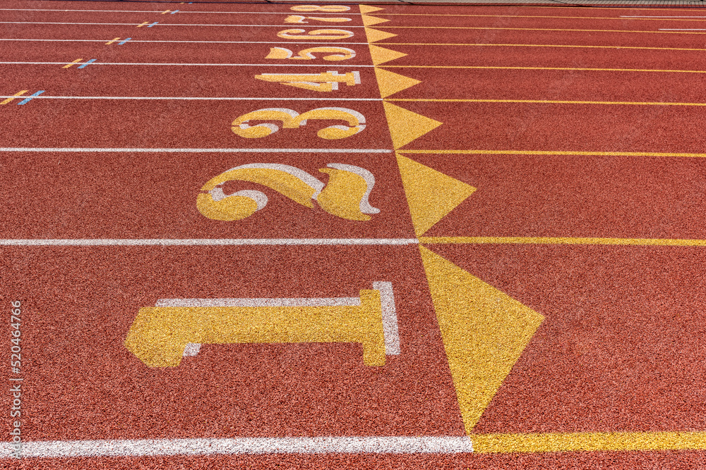 Close up of new red running track lane numbers, 1 through 8, with white ...