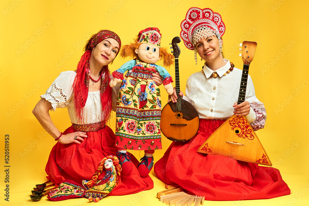 Women musicians in Russian folk dresses with musical instruments on a ...