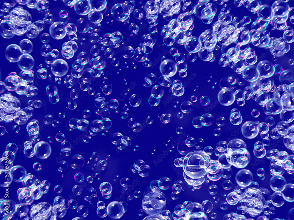 Blue background and many bubbles. Small and big bubbles float in the ...