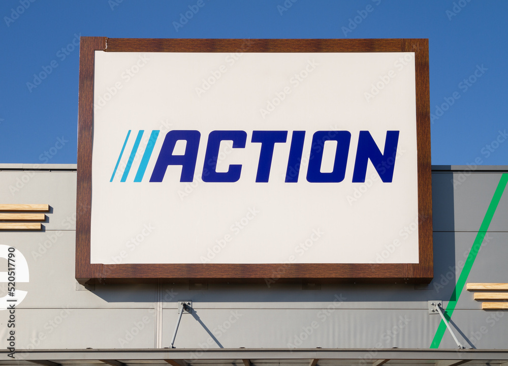 Action store with logo sign board hanging above entrance door. Dutch ...