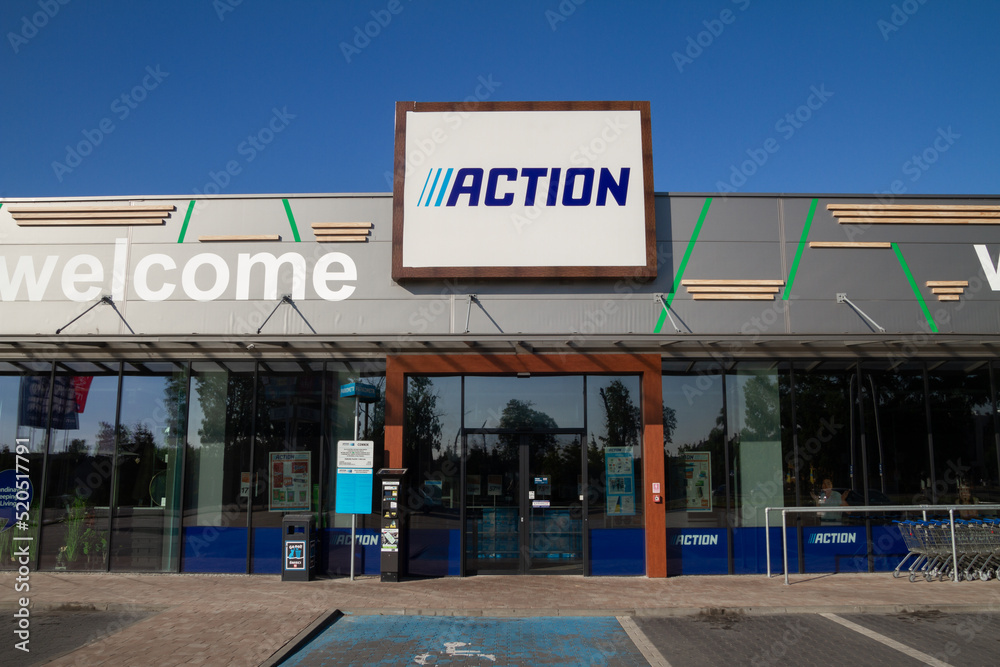 Action store with logo sign board hanging above entrance door. Dutch ...