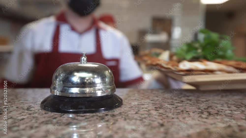 Bell ringing cook. The master who pressed the restaurant reception bell ...