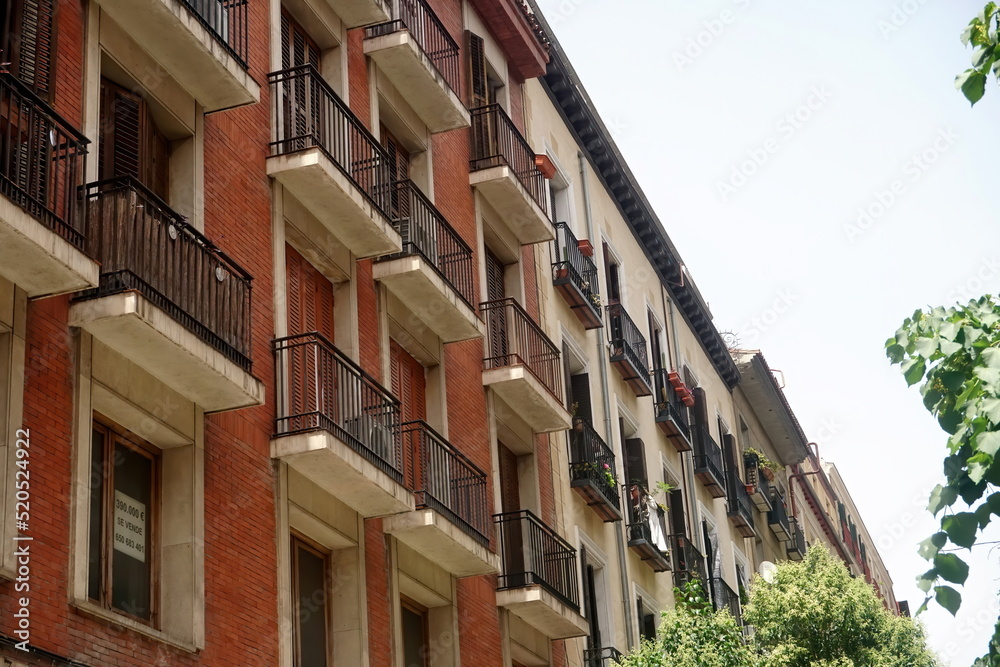 The facade of typical Spanish old house with beautiful balcony with ...