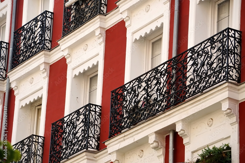 The facade of typical Spanish old house with beautiful balcony with ...
