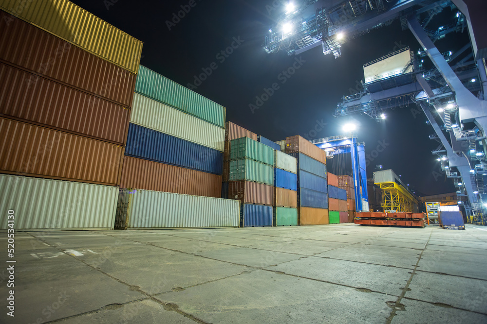 operation of container terminal at night. Unloading container ship at ...