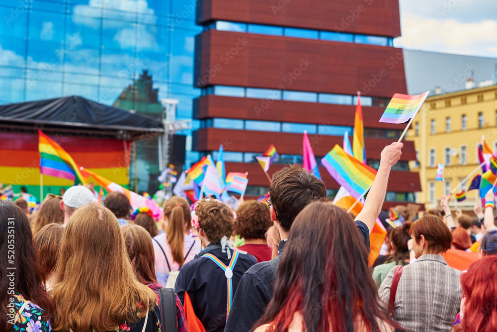 People crowd with LGBTQ rainbow flags on pride parade. Tolerance ...