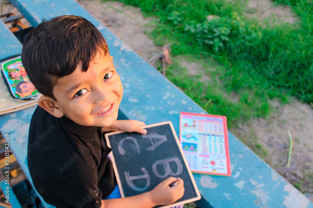Indian 5 year child writing A B C D alphabet on chalkboard,abcd ...