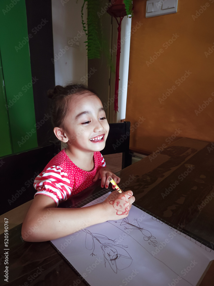 Little kid girl smiliing while drawing at home creativity development ...