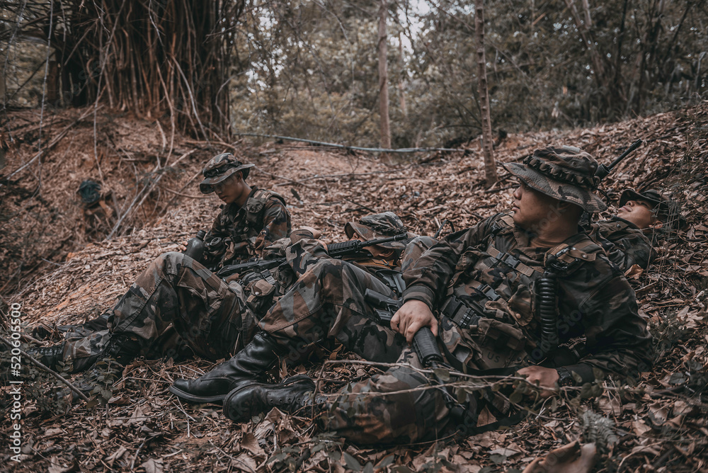 Team of army soldier with machine gun moving in the forest,Thai militia ...