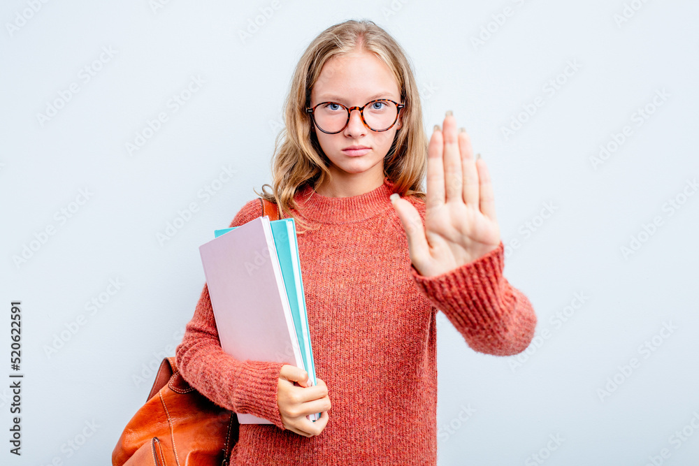Caucasian teen student woman isolated on blue background standing with ...