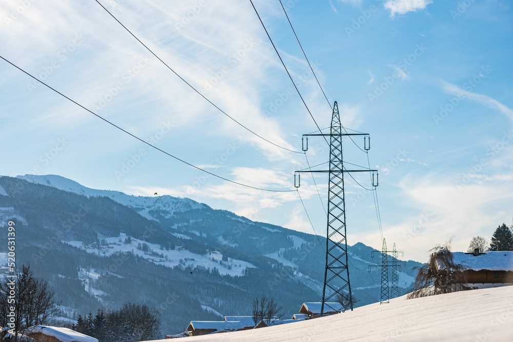 High voltage power pole with an overhead line. Winter scenery around ...