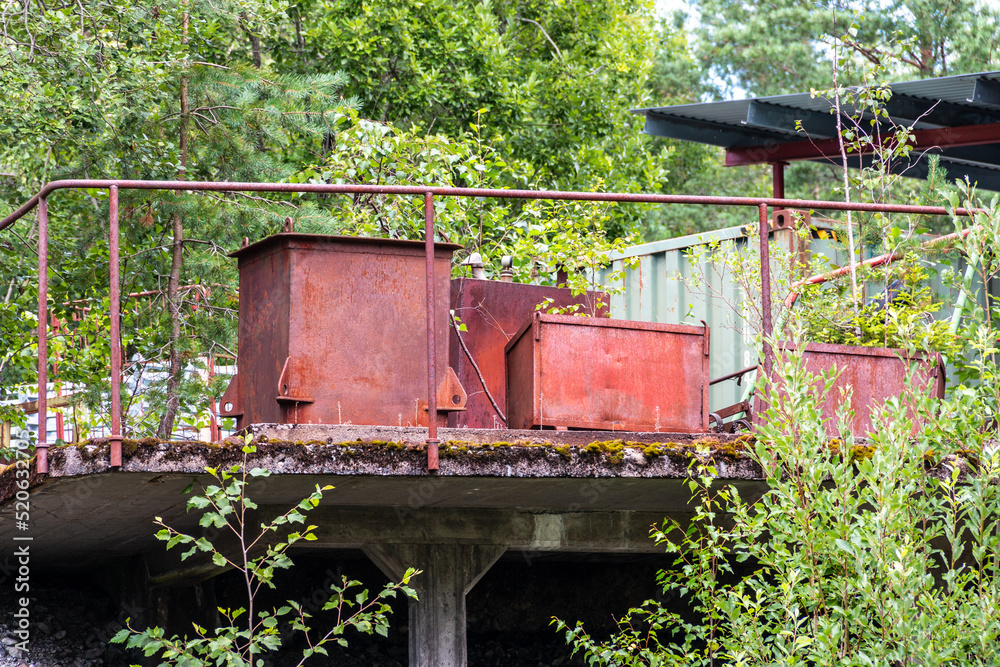 Rusted metal boxes on a ramp in an industrial setting Stock Photo ...