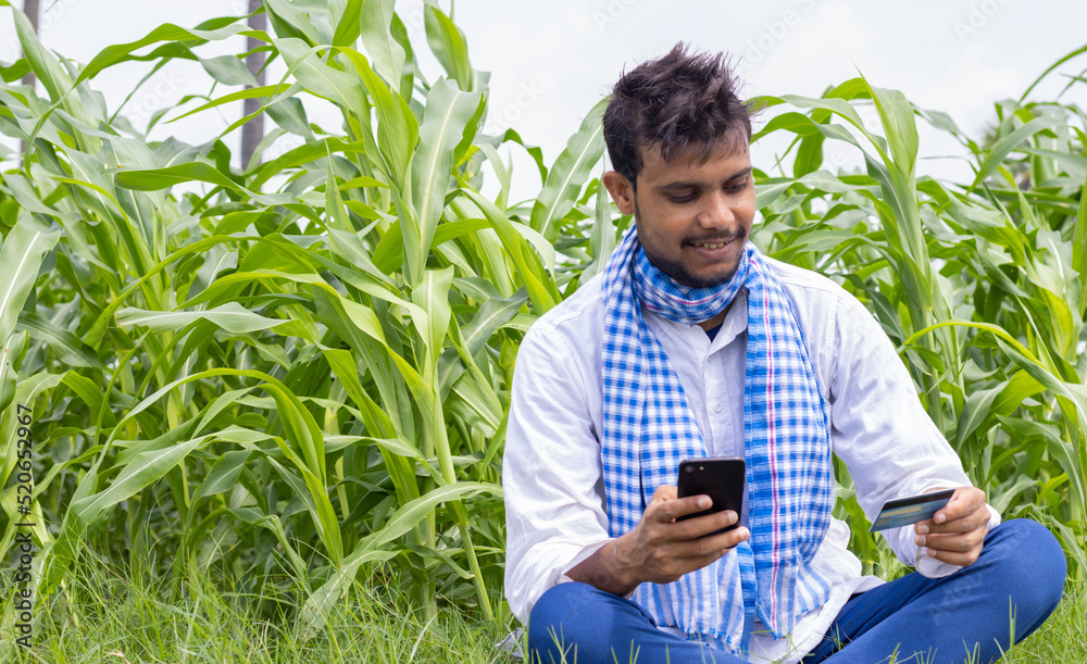 Farmer with smartphone at agriculture field Stock Photo | Adobe Stock