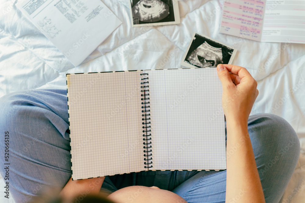 Pregnant woman writing list. Young pregnancy mother holding notepad ...