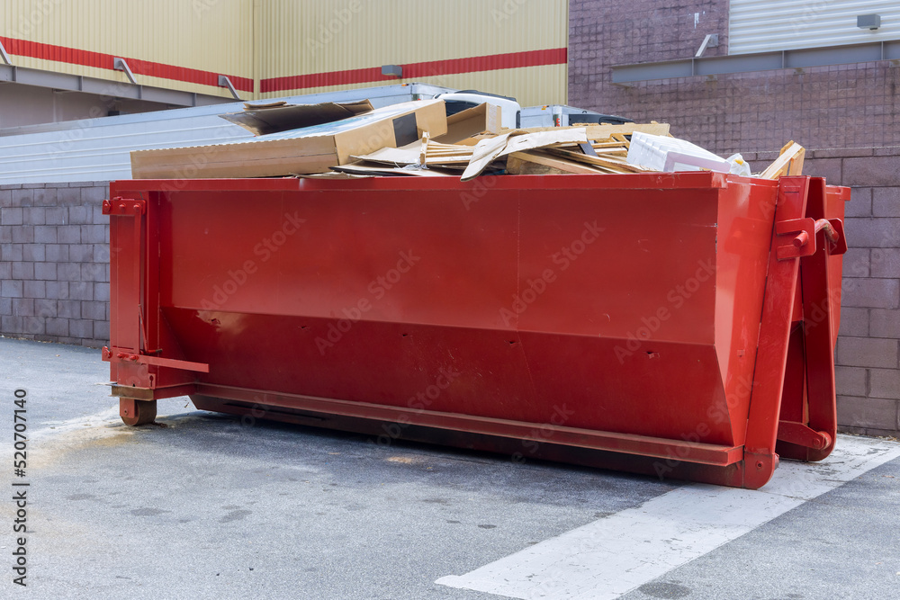 Construction site a rubbish removal container on house underneath an ...