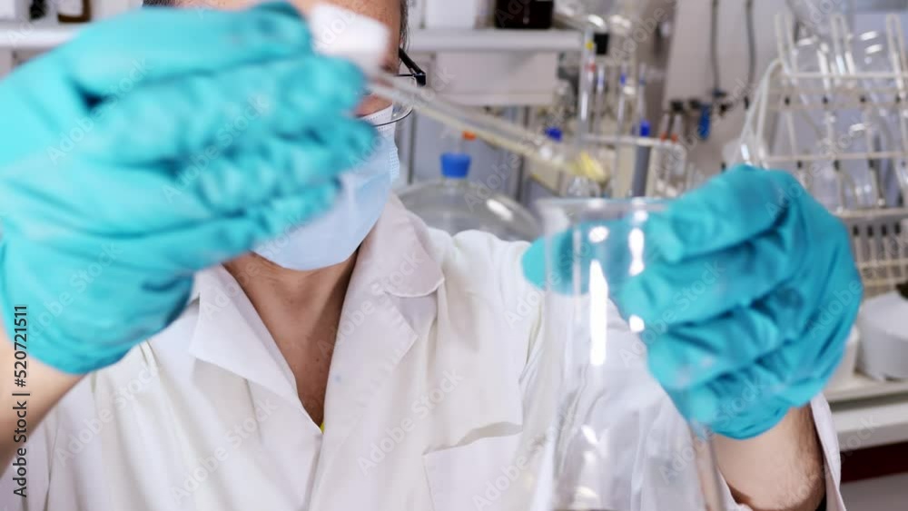 Scientist performing an experiment in a laboratory and celebrating a ...