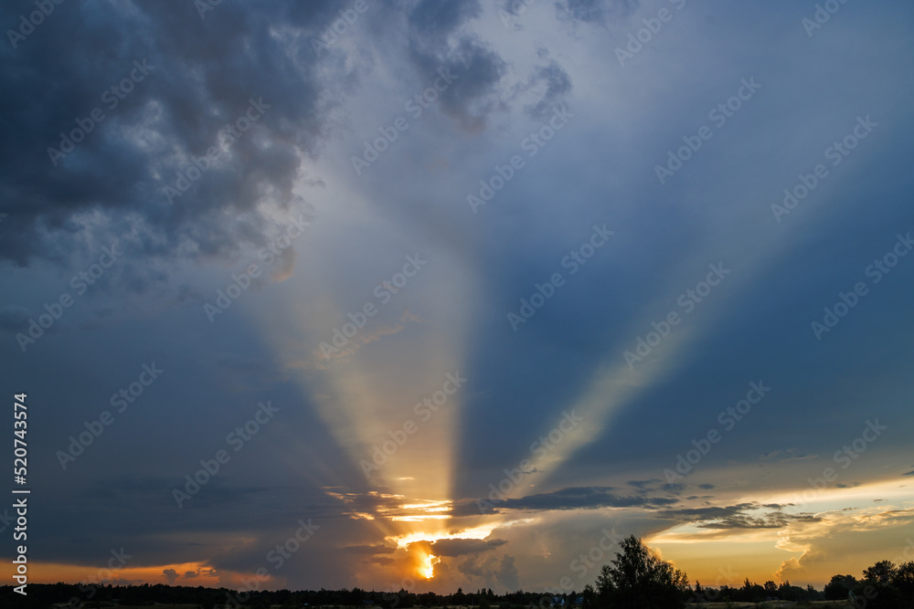cloudy sunset sky with yellow sun rays without horizon, captured with ...