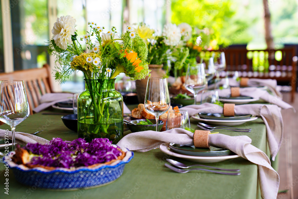 beautiful setting of a large table with flowers. Stock Photo | Adobe Stock