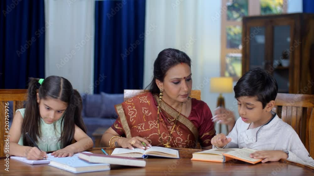 Cute Indian siblings doing their homework / studying with their mother ...