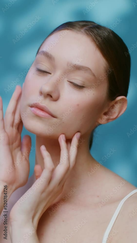 A young woman without makeup touches the clean skin of her face Stock ...