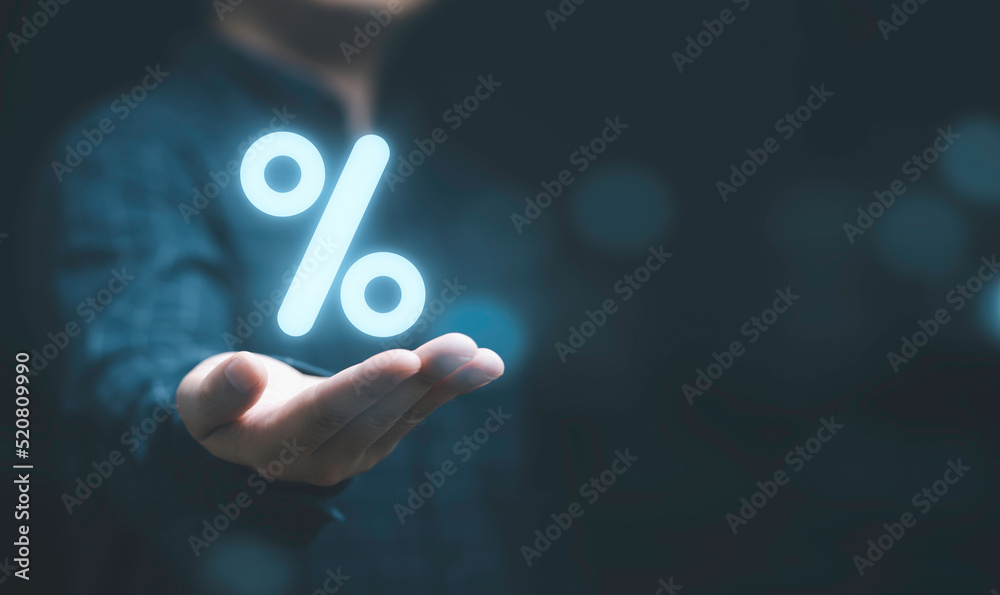 Businessman holding virtual glowing percentage sign for interest rating ...