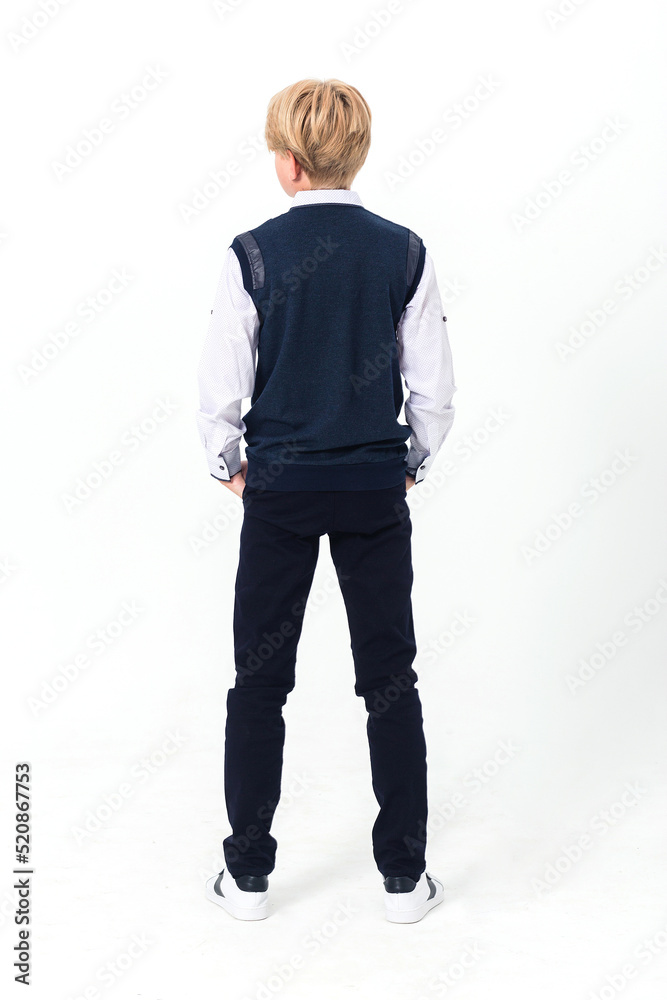 Boy posing in school uniform on white background. The boy is standing ...