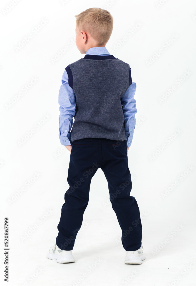 Boy, elementary school student posing in a school uniform on a white ...