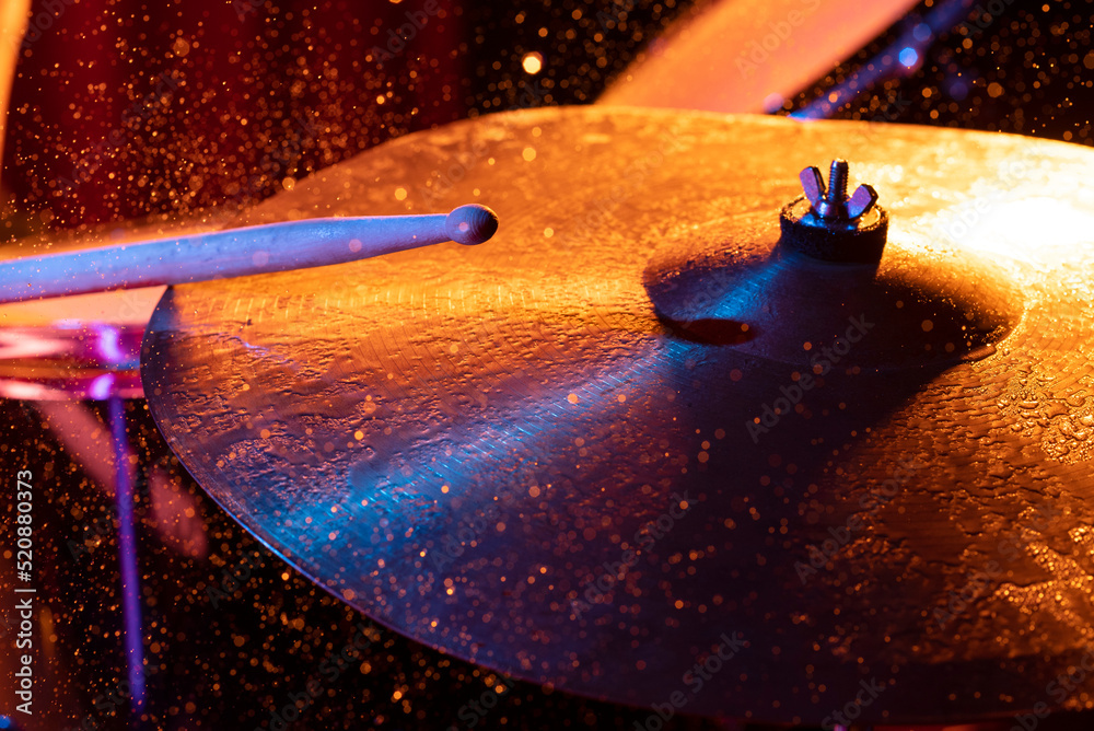 Dynamic scene. man playing the drum plate on a colored background, the ...