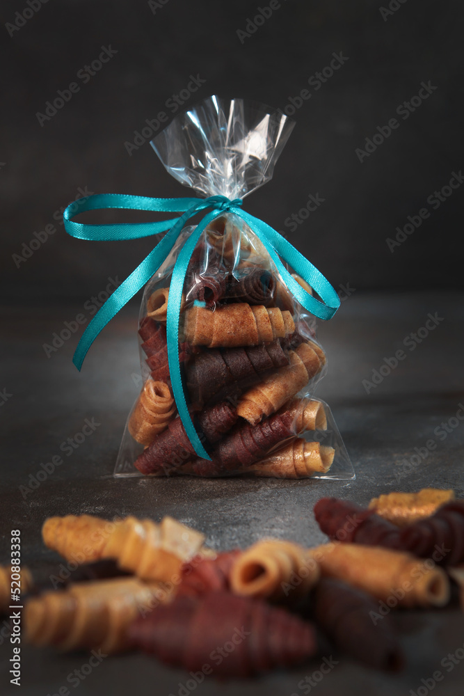 A bag with a pastille inside. The apple pastille is rolled up ...