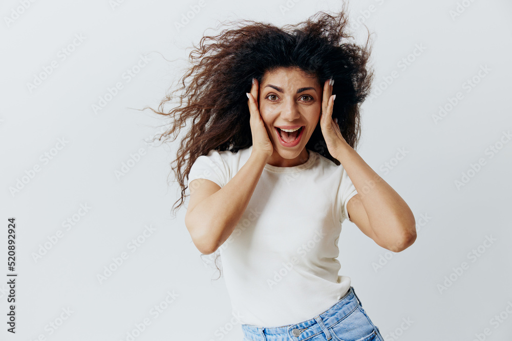 WOW OFFER. Excited beautiful curly female look at camera, touch cheek ...