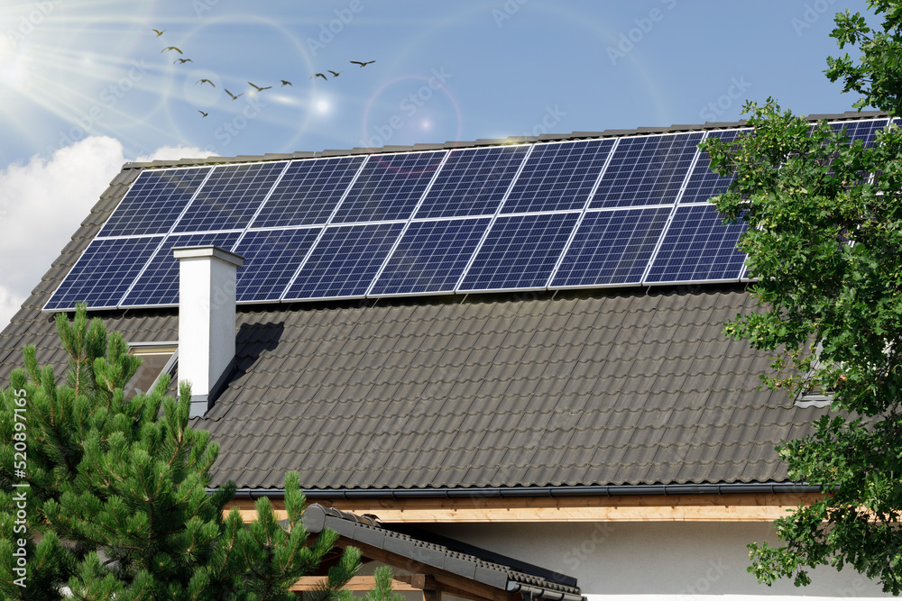 Solar panels on rooftop against blue sky and sun. Solar panels on the ...