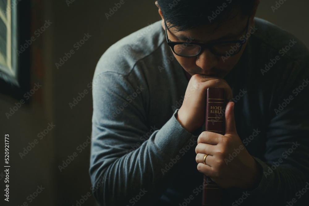 Man praying on the holy bible in the morning. Man hand with Bible ... Man praying on the holy bible in the morning. Man hand with Bible ...
