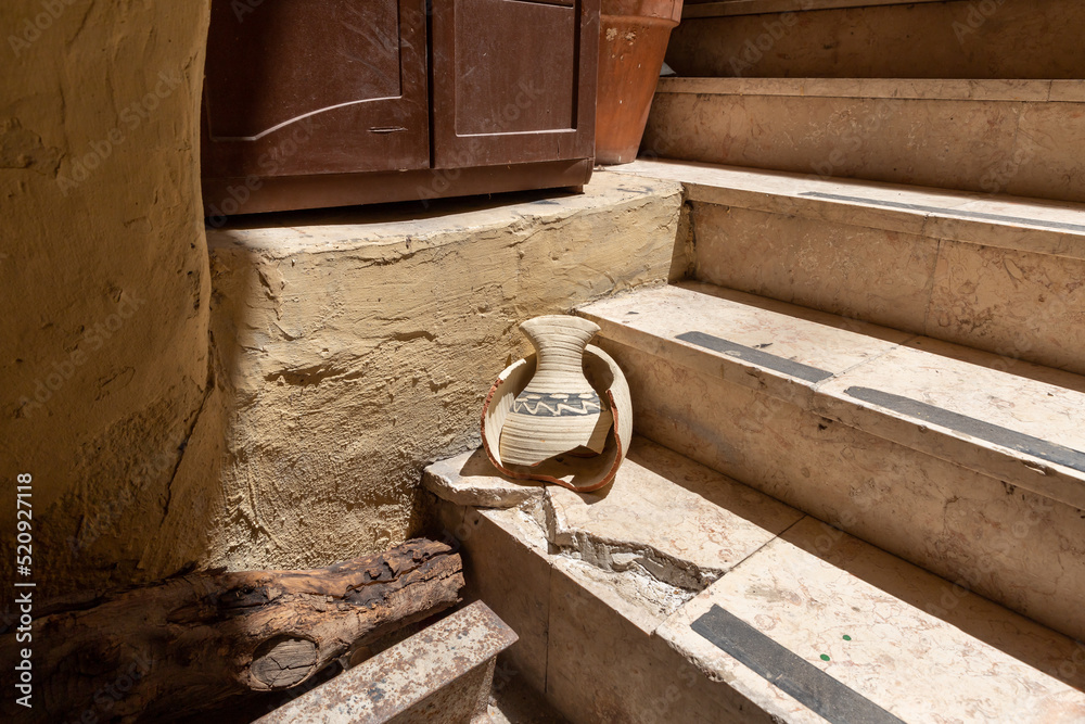 Broken clay jug as decoration near the entrance to the house on the ...