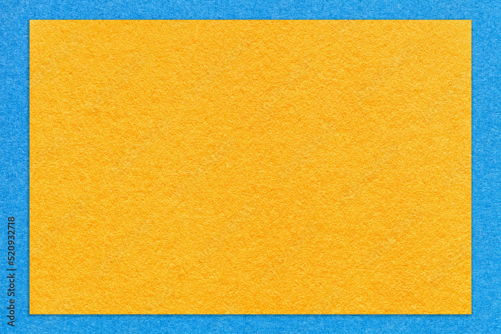 Texture of craft yellow color paper background with blue border, macro ...