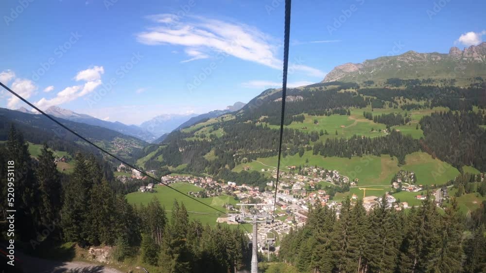 Cable car ride in the canton of Grisons. The gondola lift descends into ...