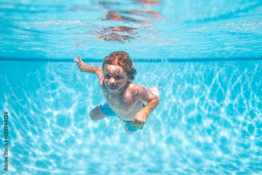 Underwater kids swims in pool, healthy child swimming and having fun ...