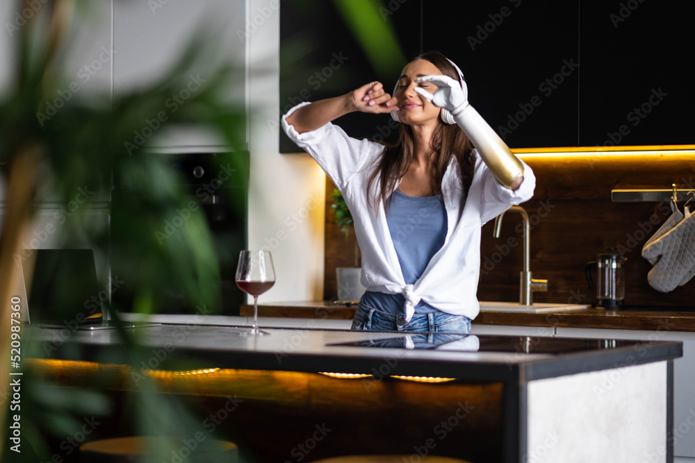 Happy girl disability prosthetic arm listening music headphones and ...