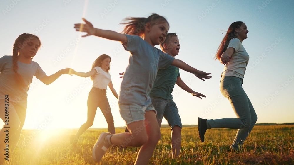 kids run in the park at sunset. friendly family children camp kid dream ...