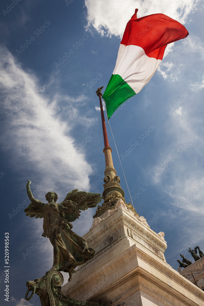 Italian flag fluttering over Vittorio Emmanuelle II National Monument ...