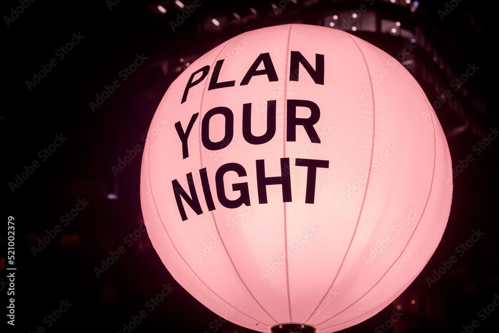 Plan your night written on a sphere at night. City night life concept ...