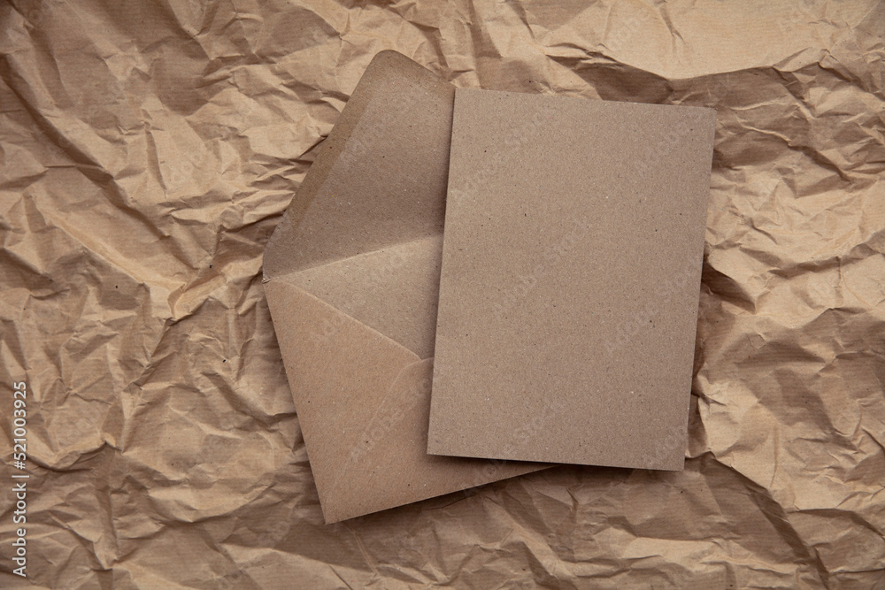 Blank card with kraft brown paper envelope template mock up on crumpled ...