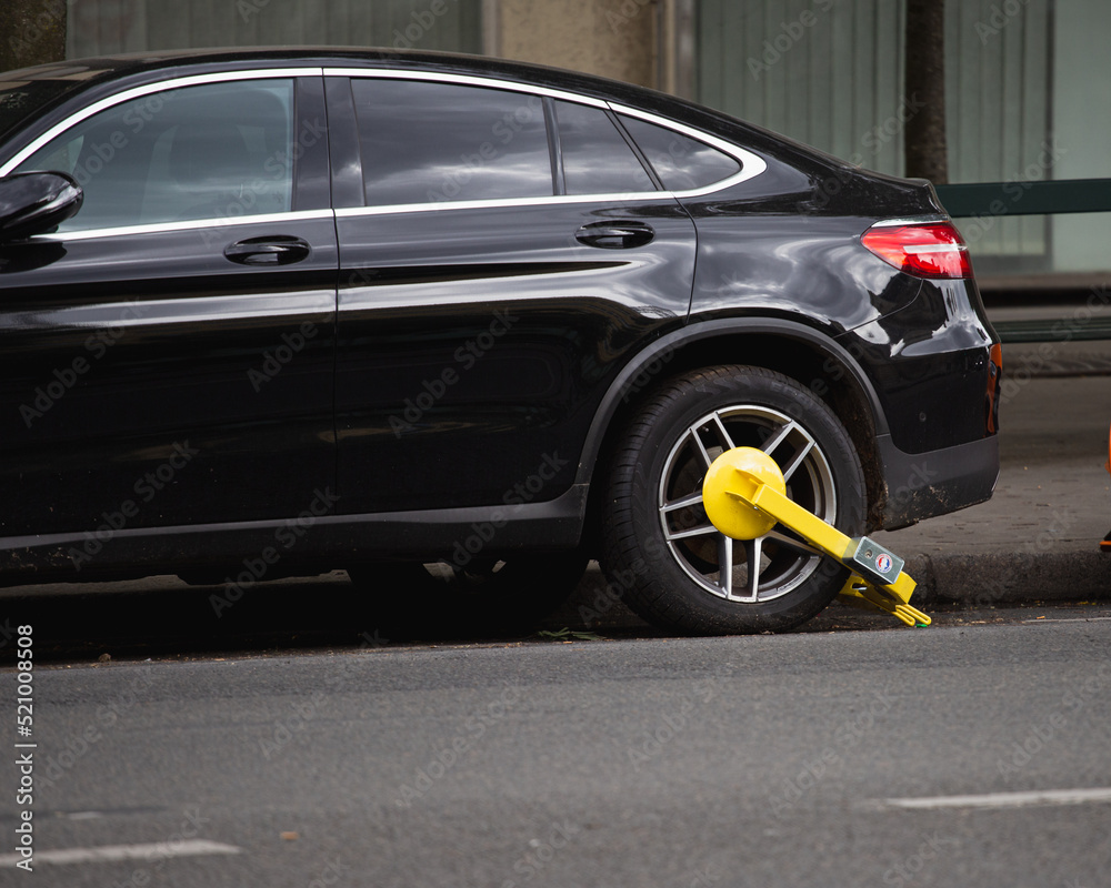 Paris, France - May 29, 2022: Police lock on car wheel for parking ...