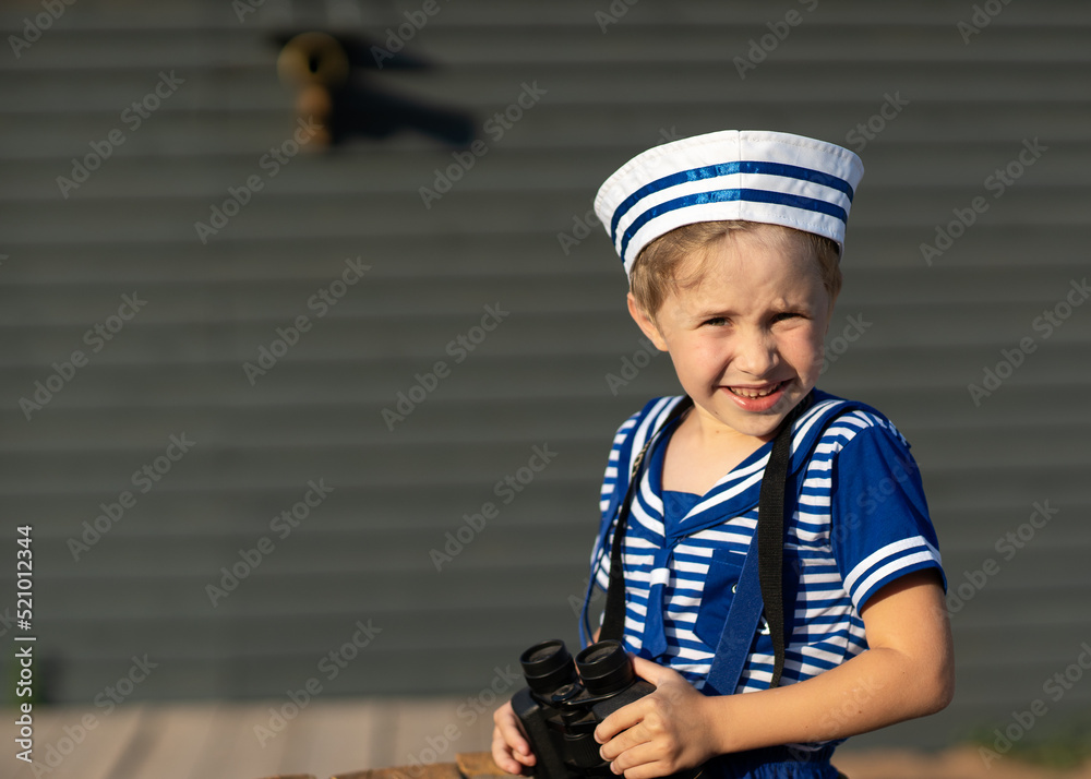 The boy is the captain of the ship. A boy in the form of a ship captain ...