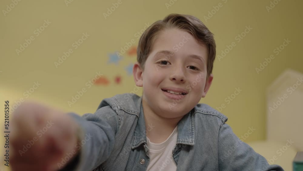 Little boy changes pages with his finger on his cell phone or computer ...