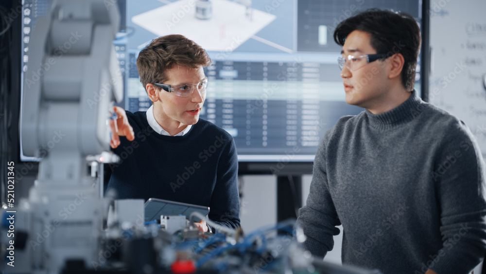 Student Pointing at Robotic Limb and Talking To Classmate While ...