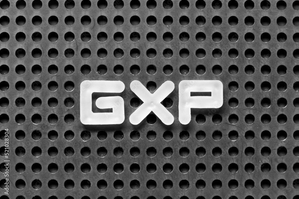 White alphabet letter in word GXP on black pegboard background Stock ...