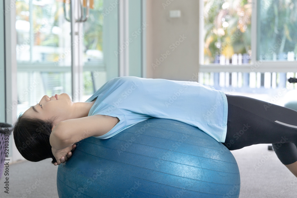 Beautiful and shapely Asian woman working out in the gym, Play exercise ...