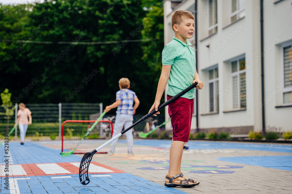Preteen boy hockey player hitting ball with hockey stick on the ...