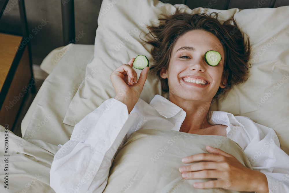 Young smiling happy woman wear white shirt pajama she lying in bed with ...